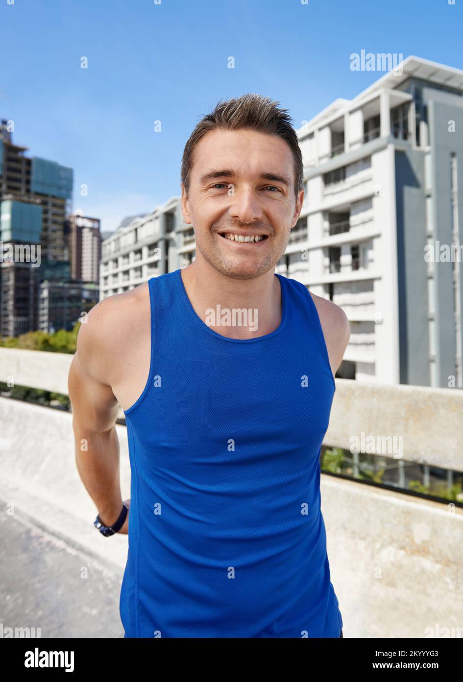 Quick warmup before the run. Handsome man stretching before his run in ...