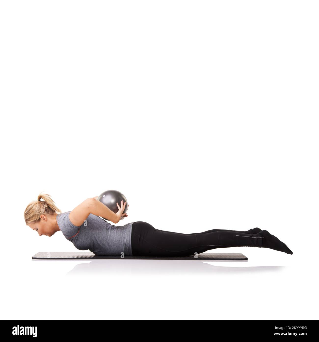 Exercise ball workouts. A pretty young woman working out with an ...