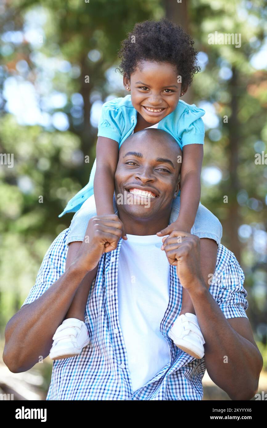 She loves the forest as much as daddy. Portrait of a father carrying his daughter on his ...
