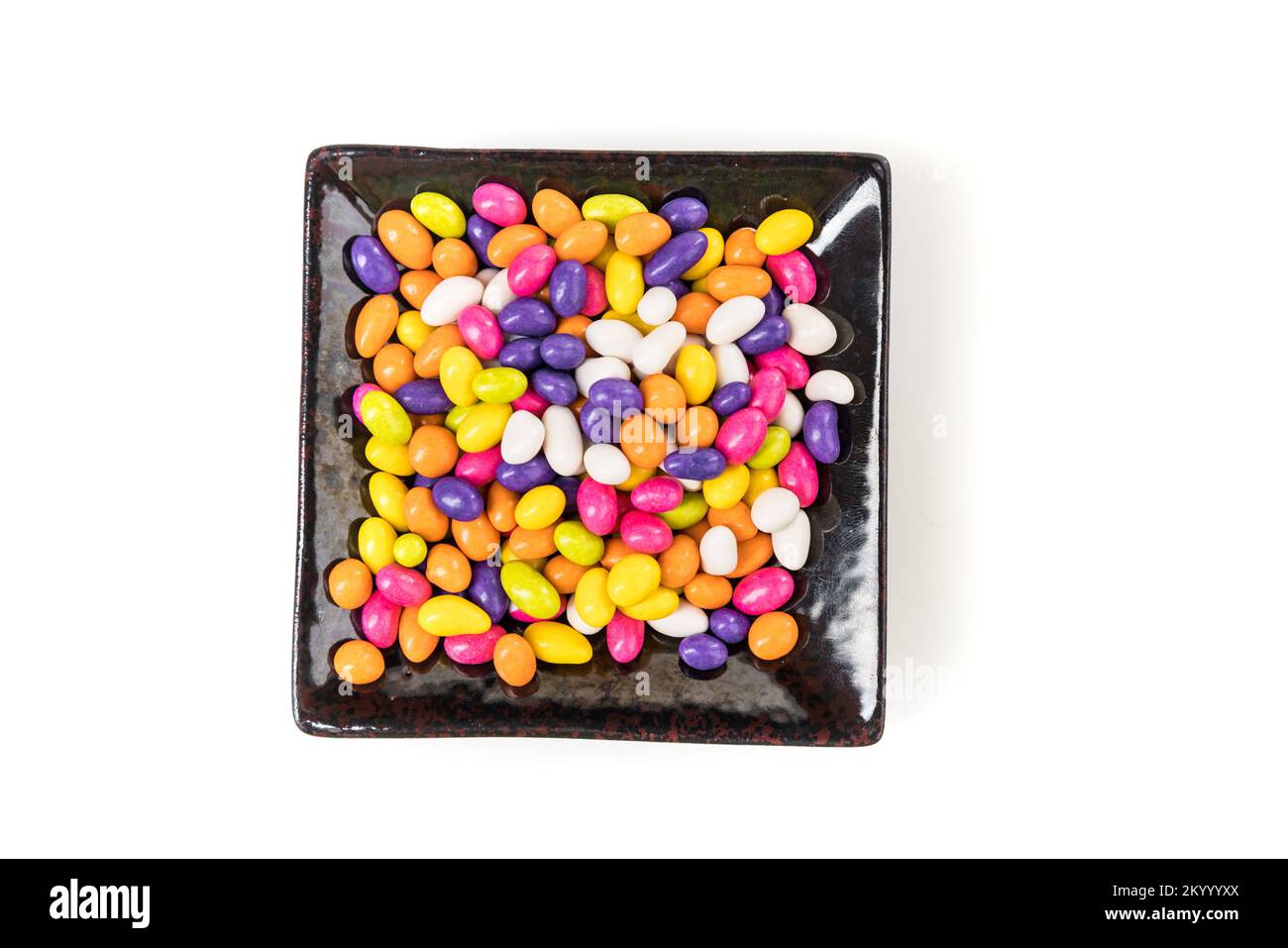 Multicolored fennel candy in a black tray isolated over white ...