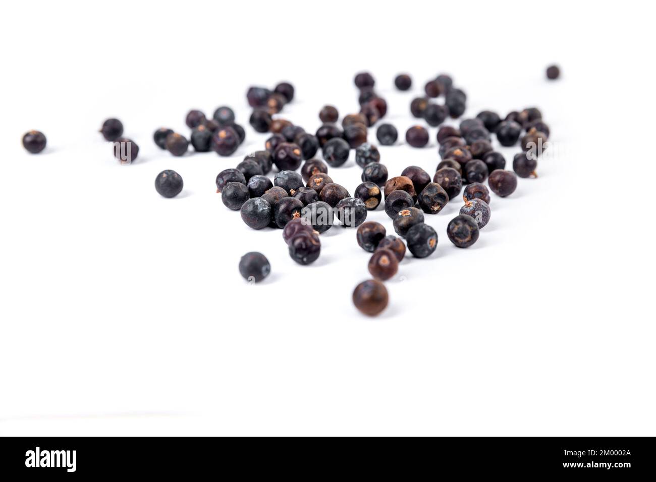 Juniper berries scattered background isolated over white side view ...