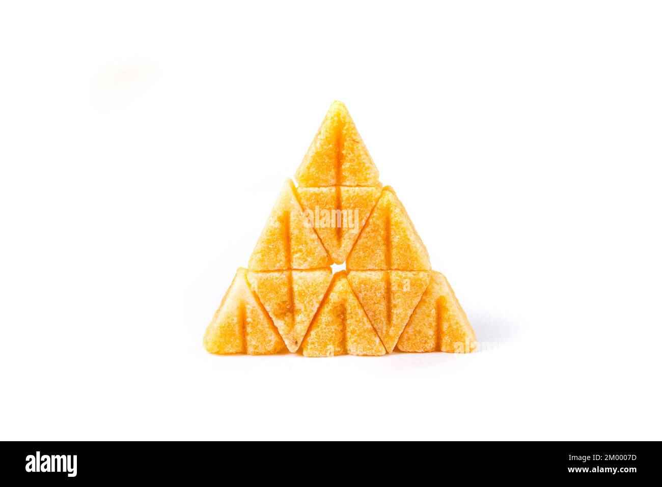 Saffron spiced sugar cubes stacked in a pyramid isolated over white ...