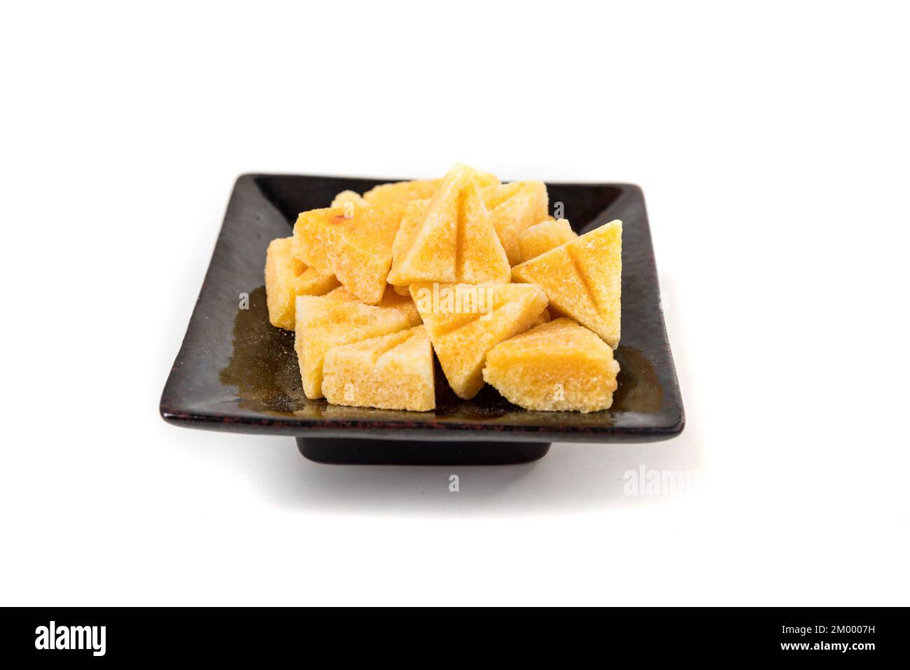Saffron spiced sugar cubes in a pile on a black tray side view Stock ...