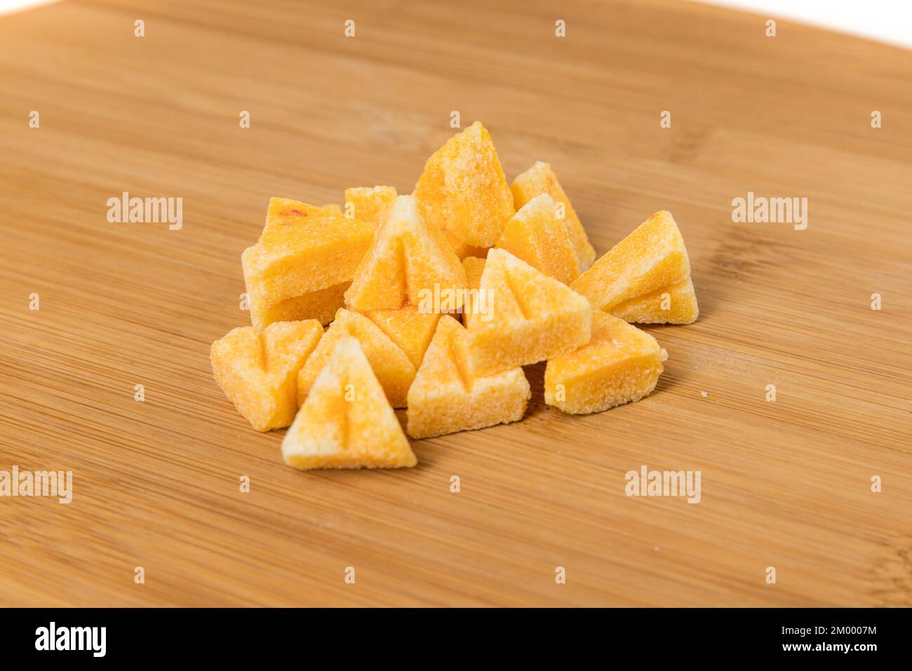 Saffron spiced sugar cubes in a pile on a wood cutting board Stock ...