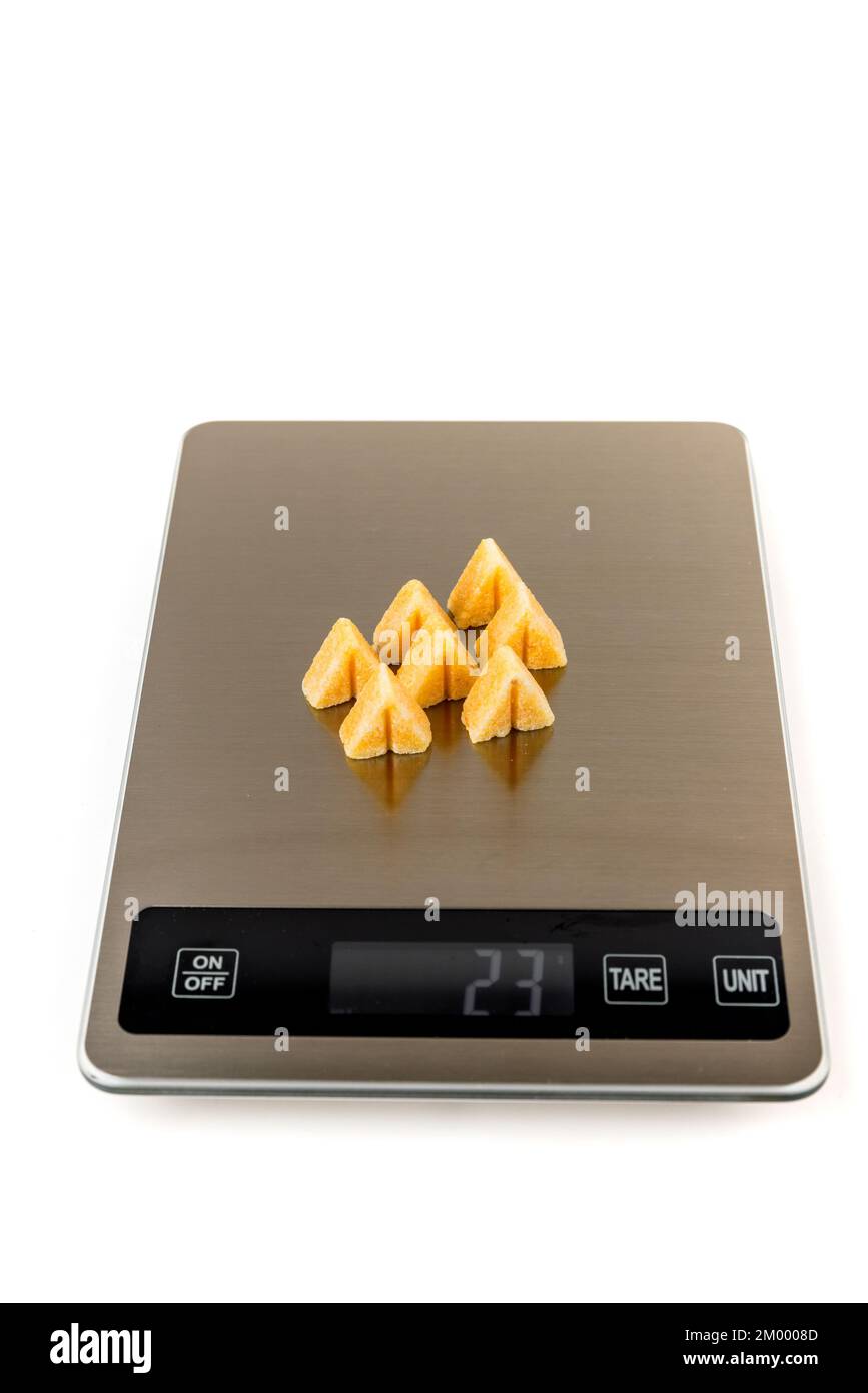 Saffron spiced sugar seven cubes on a scale over white Stock Photo - Alamy