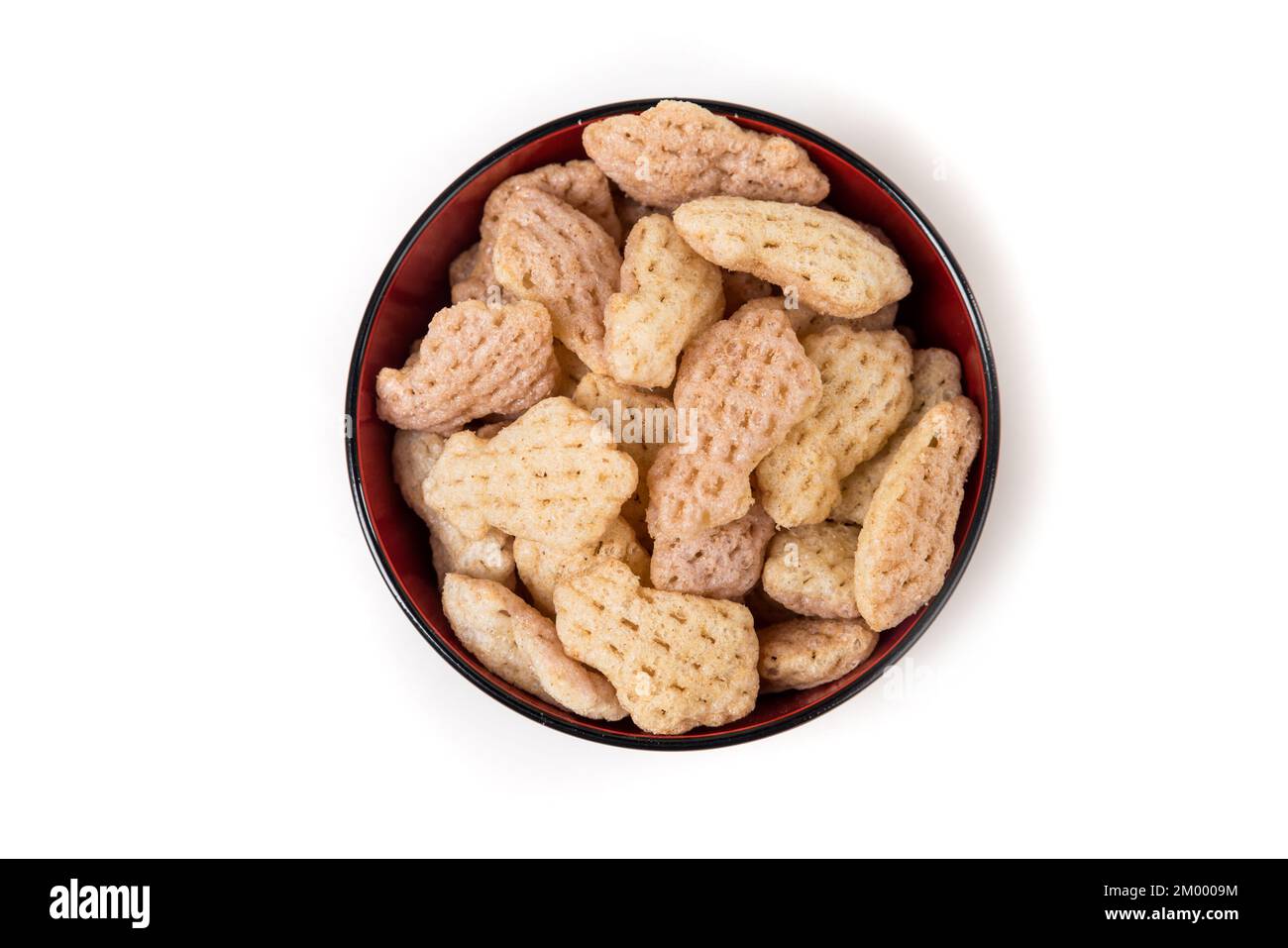 Cuttlefish snack crisps in an orange bowl isolated over white top down ...