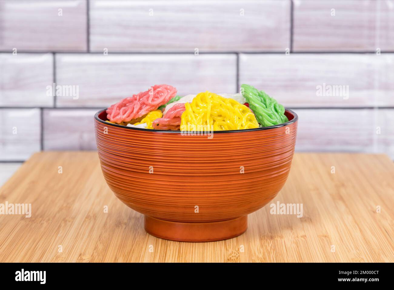Raw multicolored tapioca crackers in an orange bowl Stock Photo - Alamy