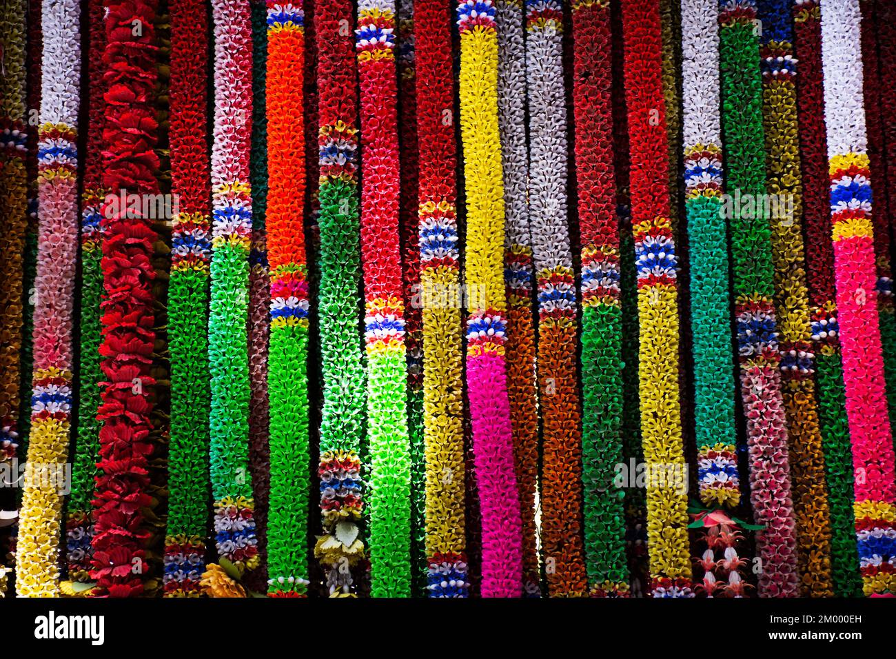 Background colorful plastic flower garland for offerings antique angel ...