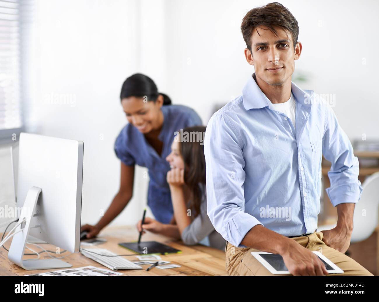 Getting ahead in the creative business word. A handsome young retoucher ...