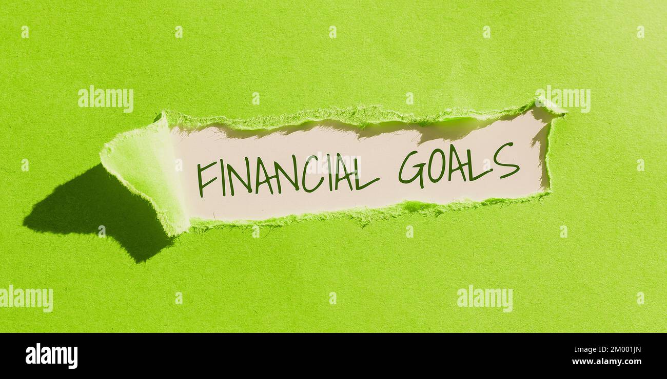 Hand writing sign Financial Goals. Word Written on targets usually ...