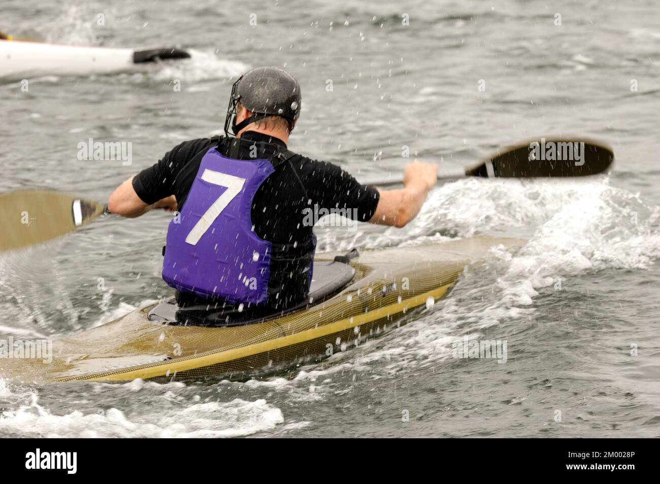 Man is racing in his kayak Stock Photo - Alamy