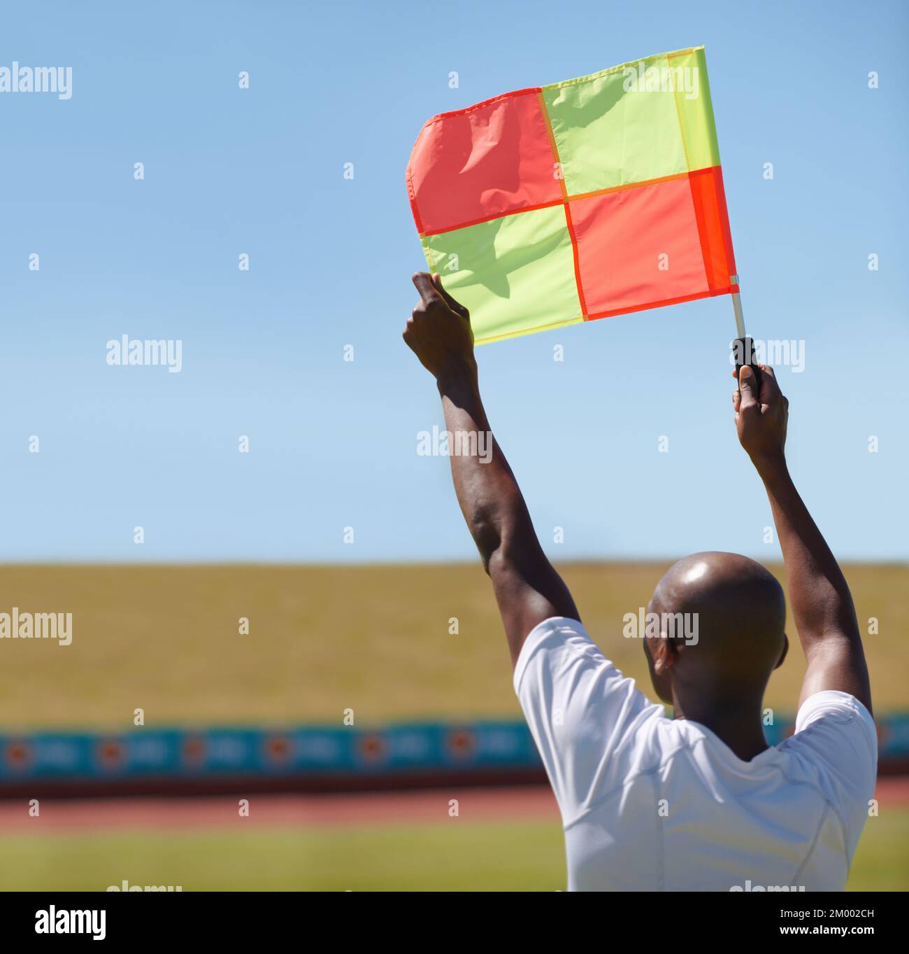 Signaling a foul. A linesman with a raised flag signaling a foul Stock ...