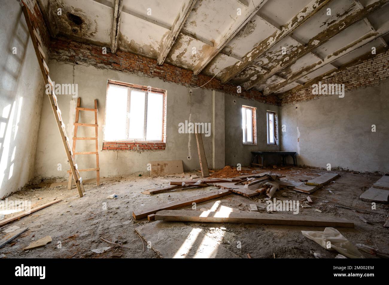 An abandoned warehouse that has been destroyed by people and time, a ...