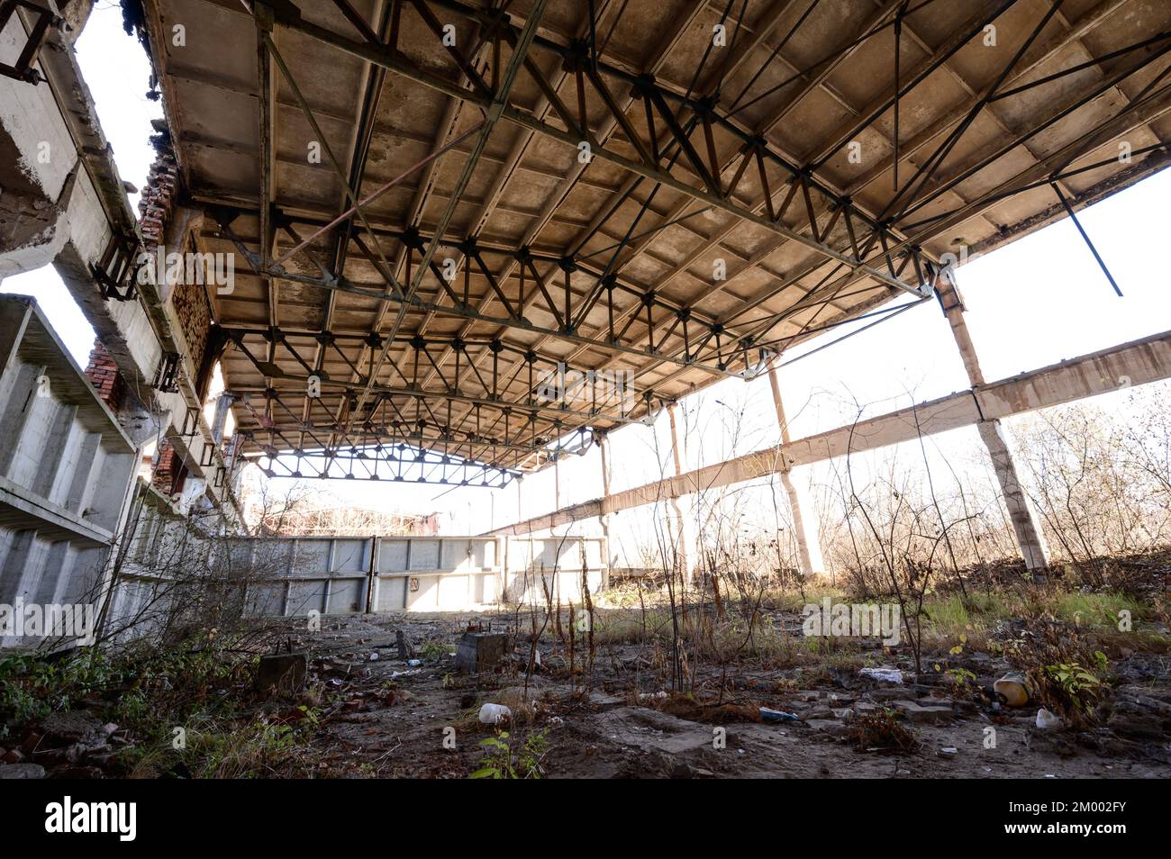 An abandoned warehouse that has been destroyed by people and time, a ...