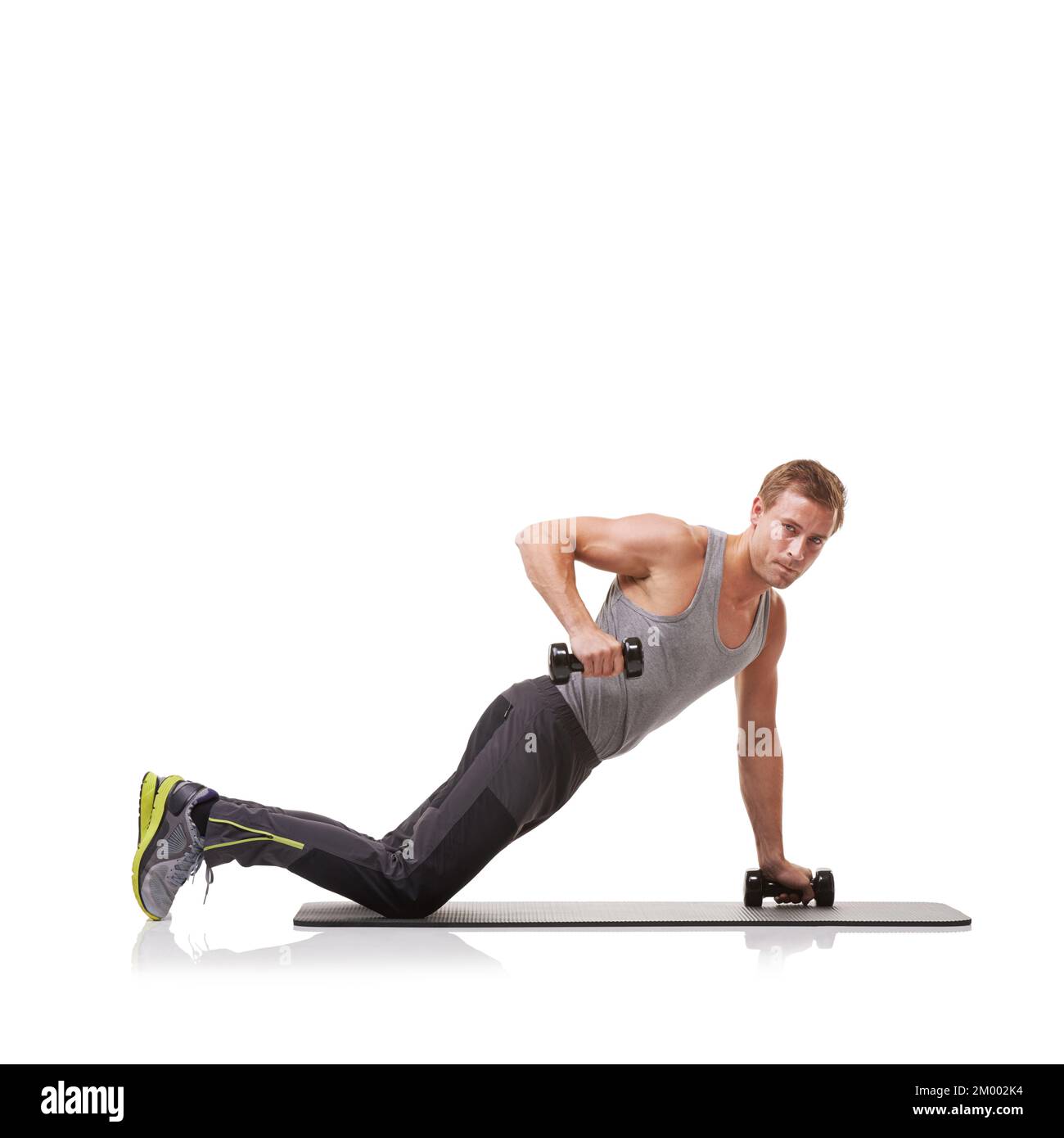 Doing the row technique. A fit young man performing the row exercise ...