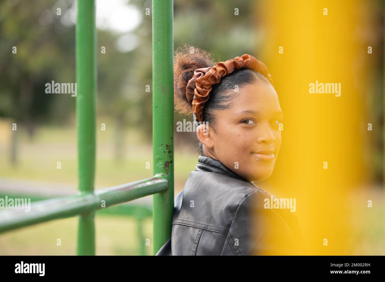 Portrait of young woman looking back Stock Photo - Alamy