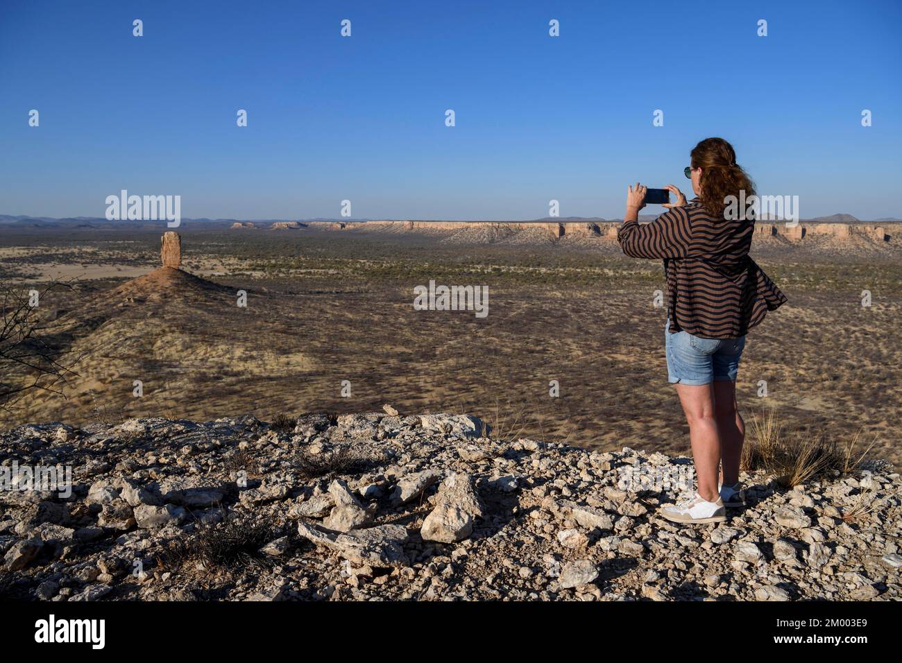 Tourist photographing the Finger Cliff, Vingerklip, rocky outcrop in ...