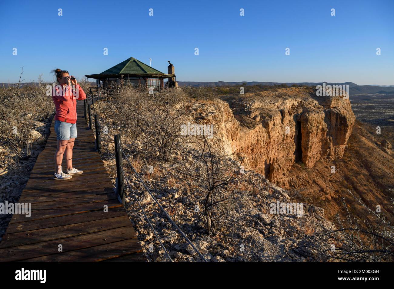 Tourist looking through binoculars, viewpoint at Eagles Nest ...