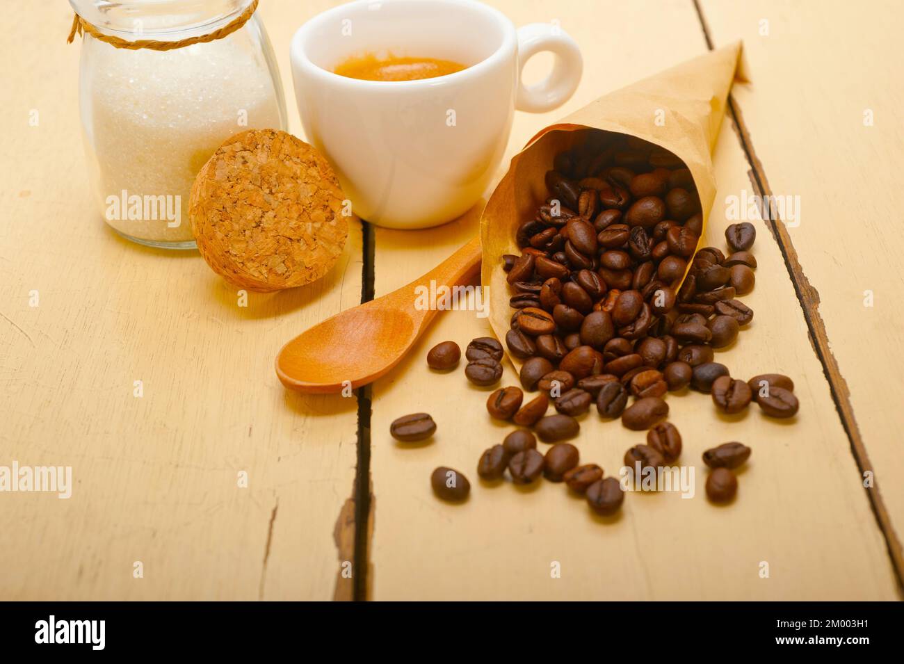 Espresso coffee and beans on a paper cone cornucopia over white ...