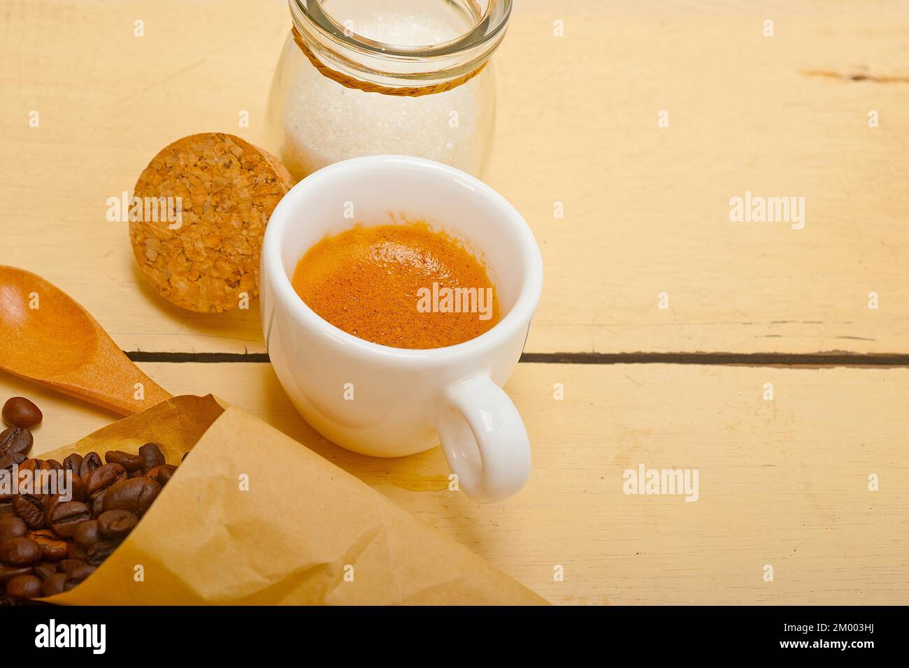 Espresso coffee and beans on a paper cone cornucopia over white ...