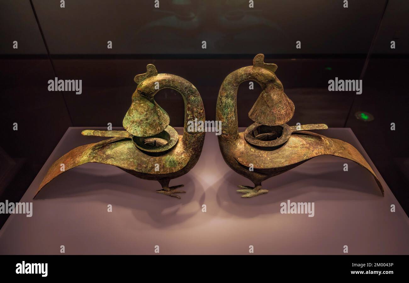 NANNING, CHINA - DECEMBER 1, 2022 - A feathered bronze phoenix lamp ...