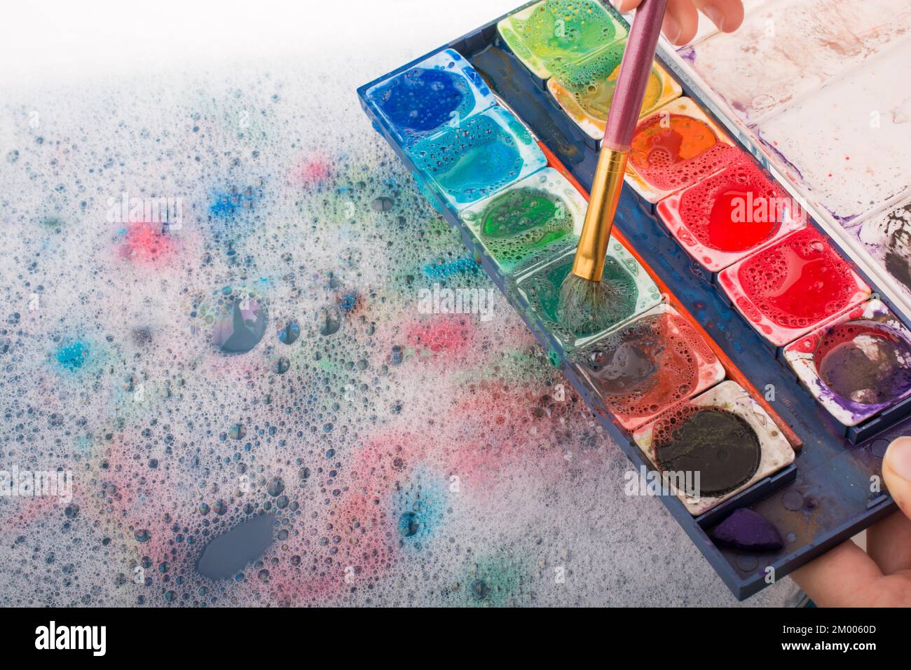 Paint dissolving in water as painting brush touching water Stock Photo ...
