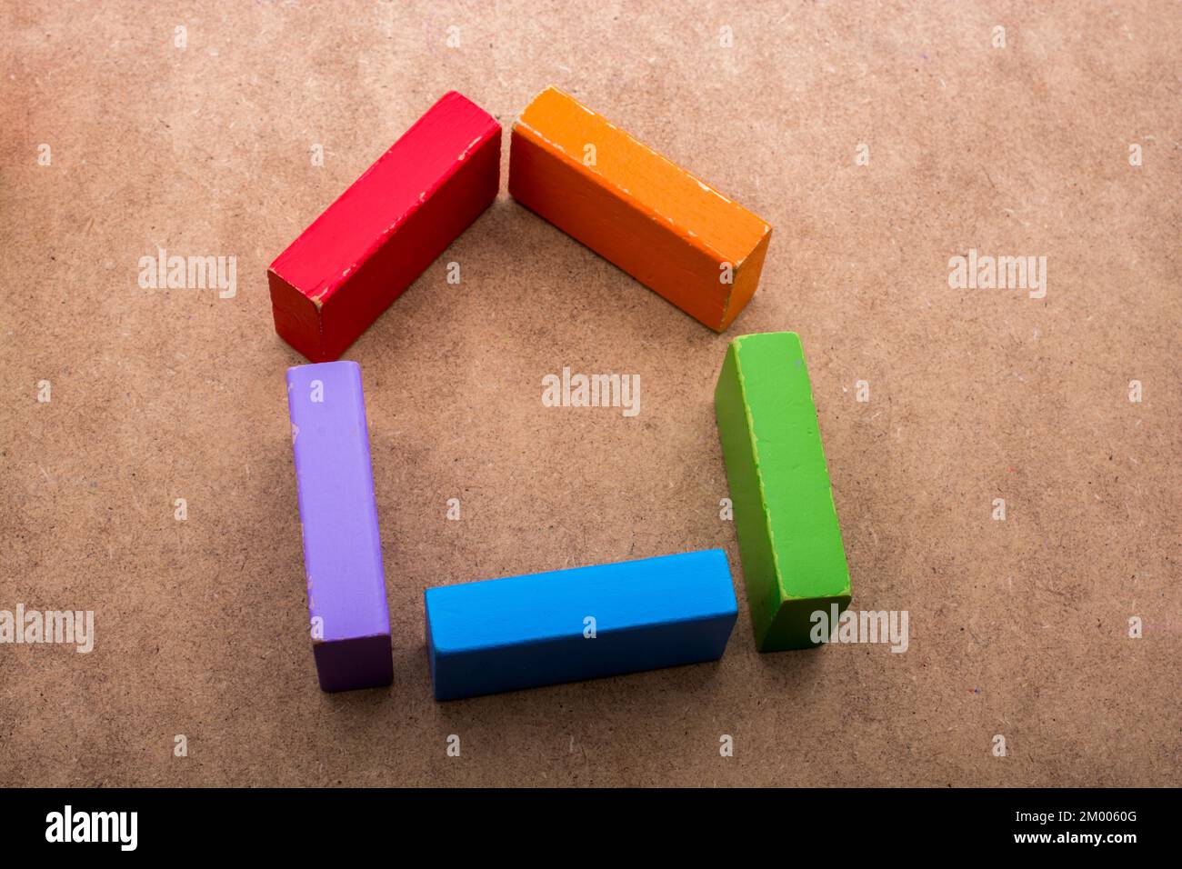 House shape formed out of building blocks on a brown background Stock ...