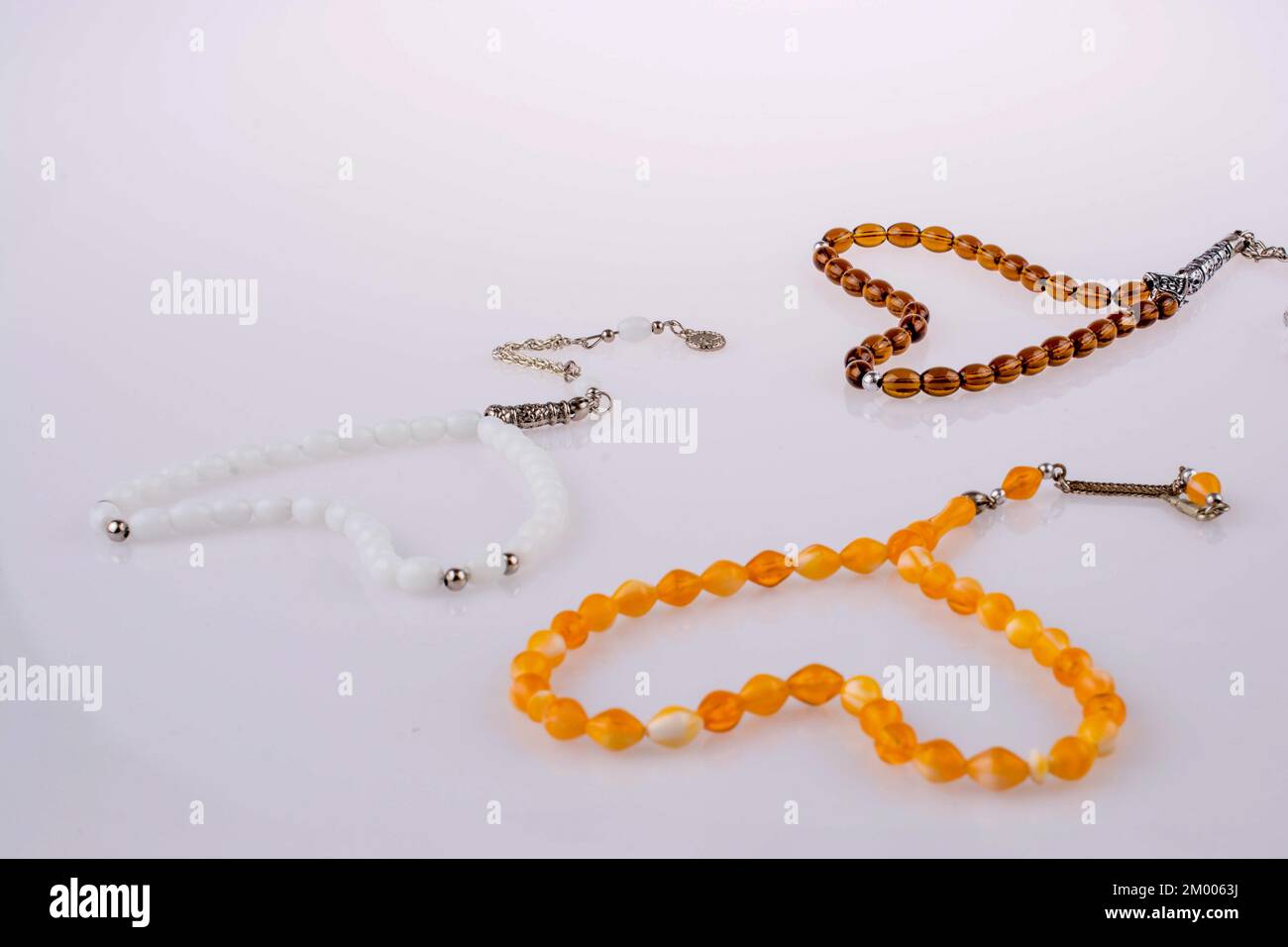 Heart shaped praying beads on a white background Stock Photo - Alamy