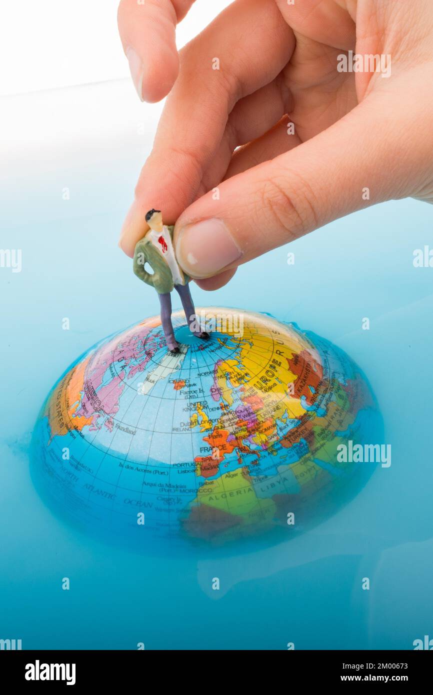 Hand in hand holding a globe hi-res stock photography and images - Alamy