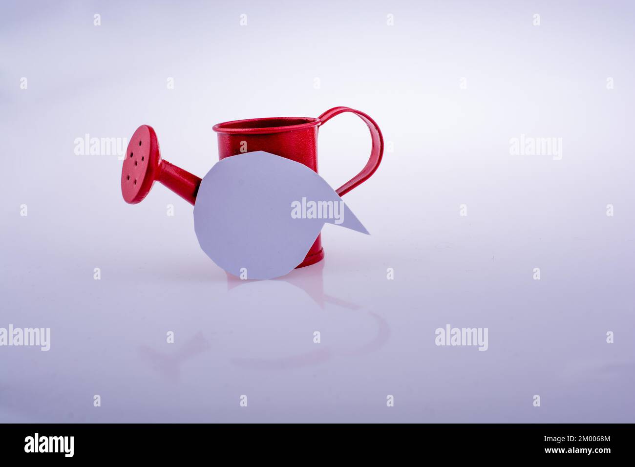 Blank empty speech bubble and a watering can Stock Photo - Alamy