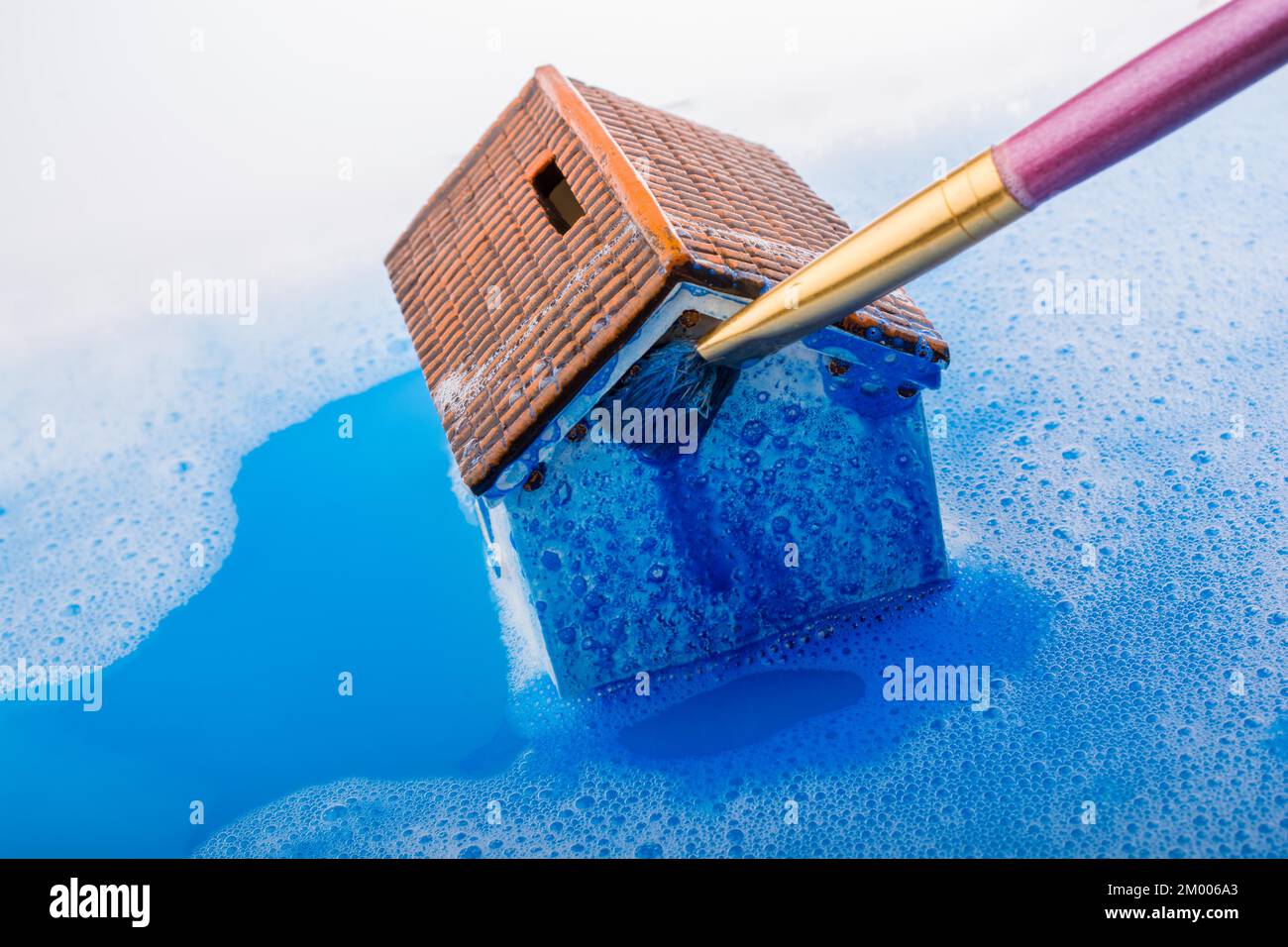 Little model house and a painting brush in foamy water Stock Photo - Alamy