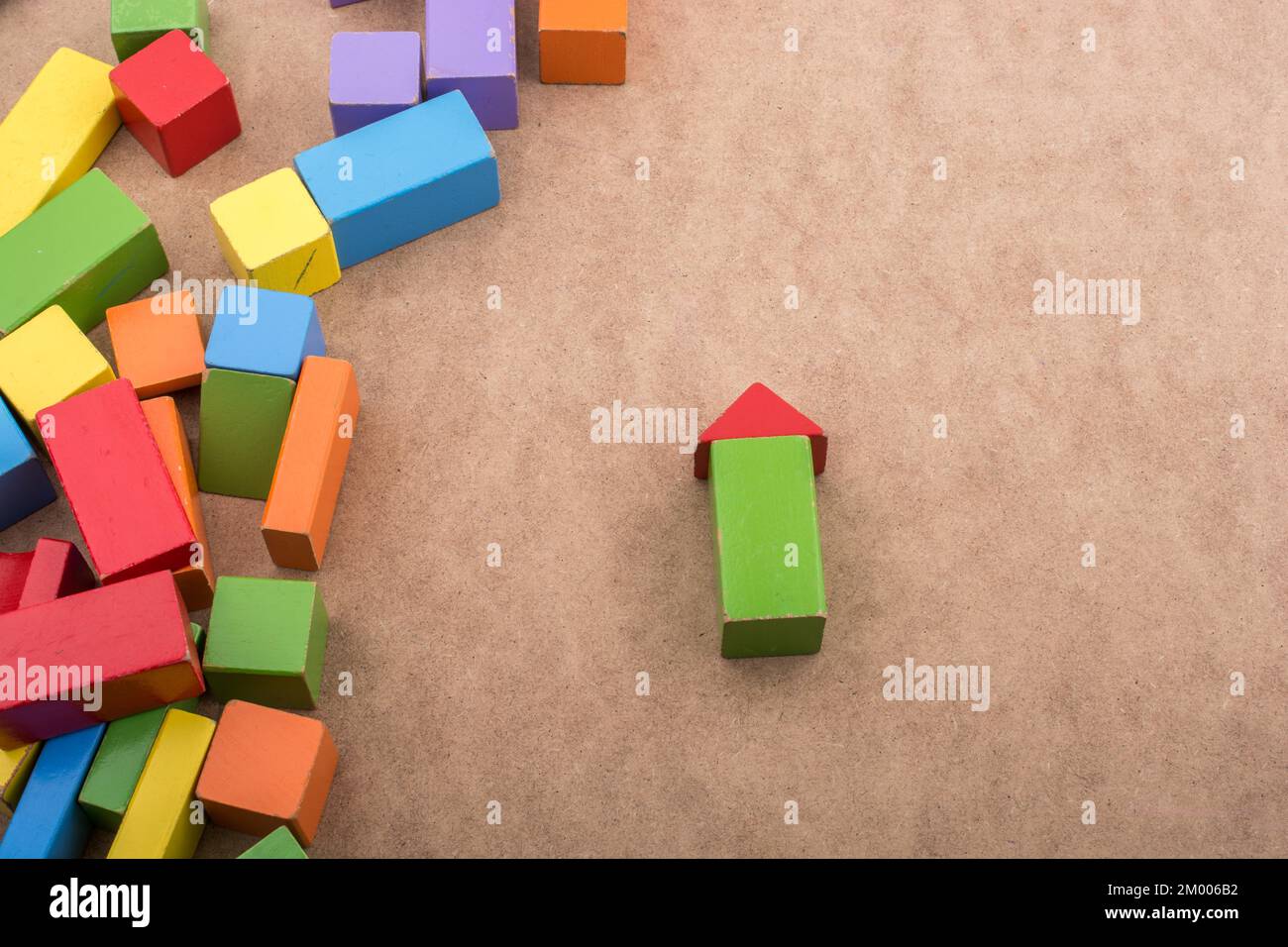 House shape formed out of building blocks on a brown background Stock ...