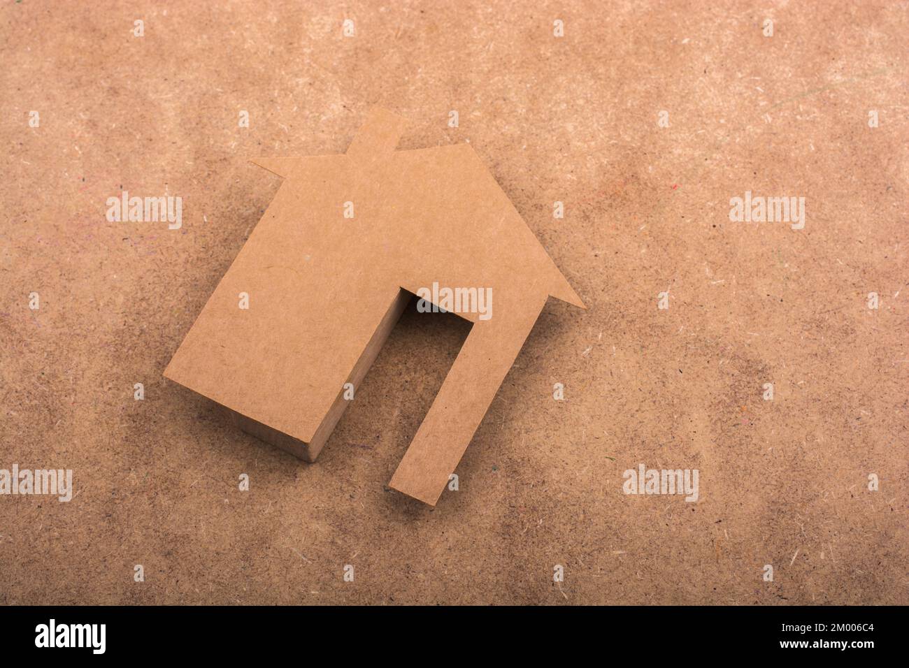Little paper houses on a brown background Stock Photo - Alamy
