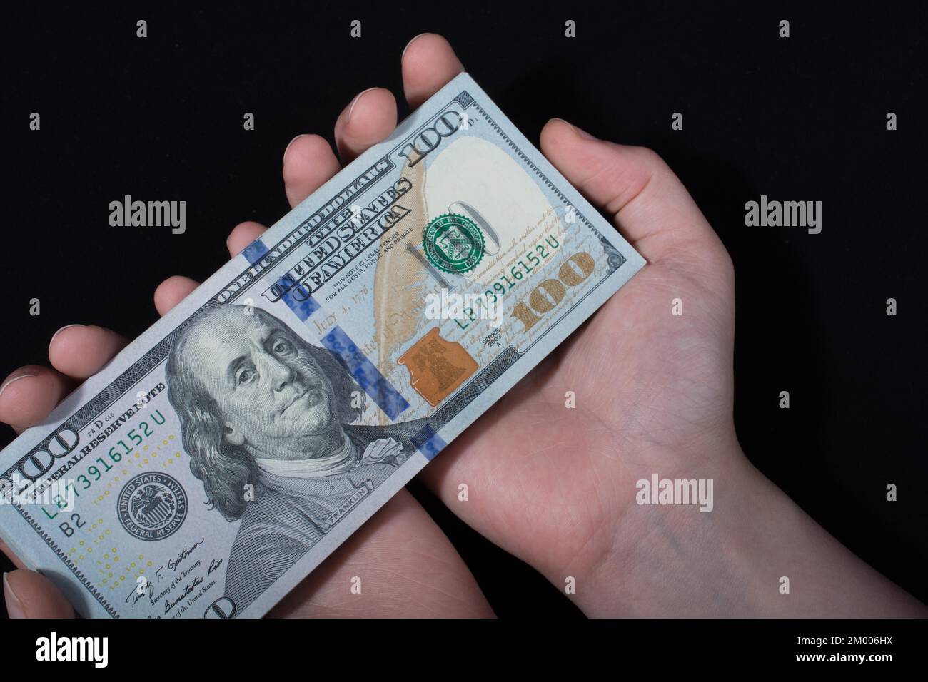 Hand holding American dollar banknotes isolated on white background ...
