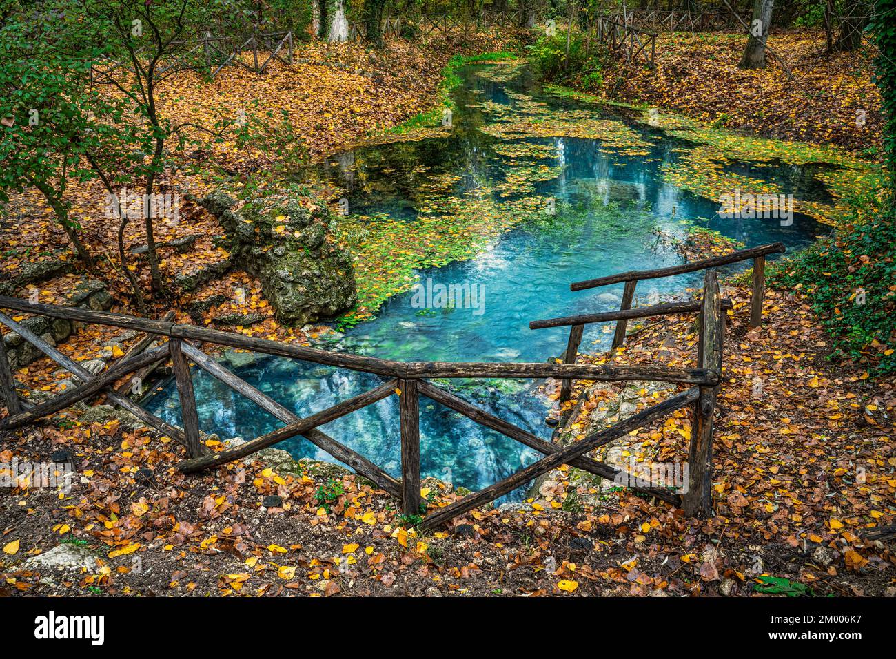 The turquoise sulphurous water contrasts with the yellow and red leaves ...