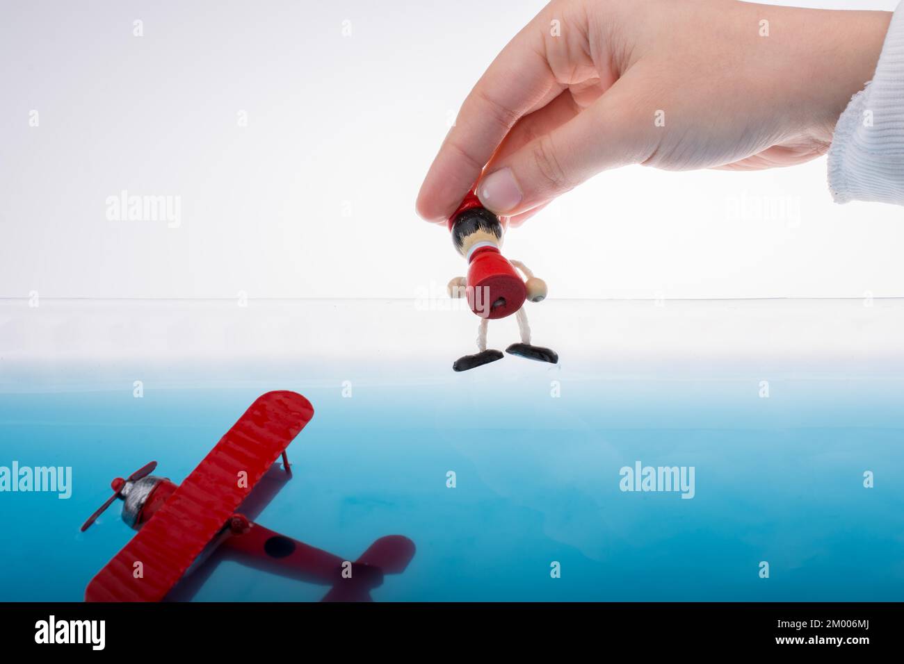 Pinocchio and a model airplane in water Stock Photo - Alamy