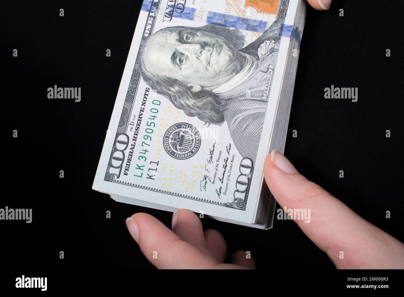 Hand holding American dollar banknotes isolated on white background ...
