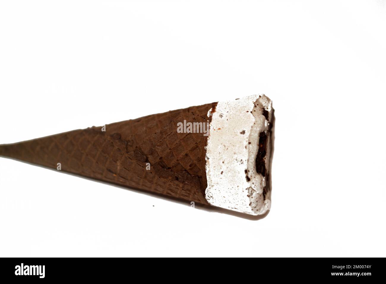 Ice cream vanilla cone with topping of chocolate chips pieces in a ...