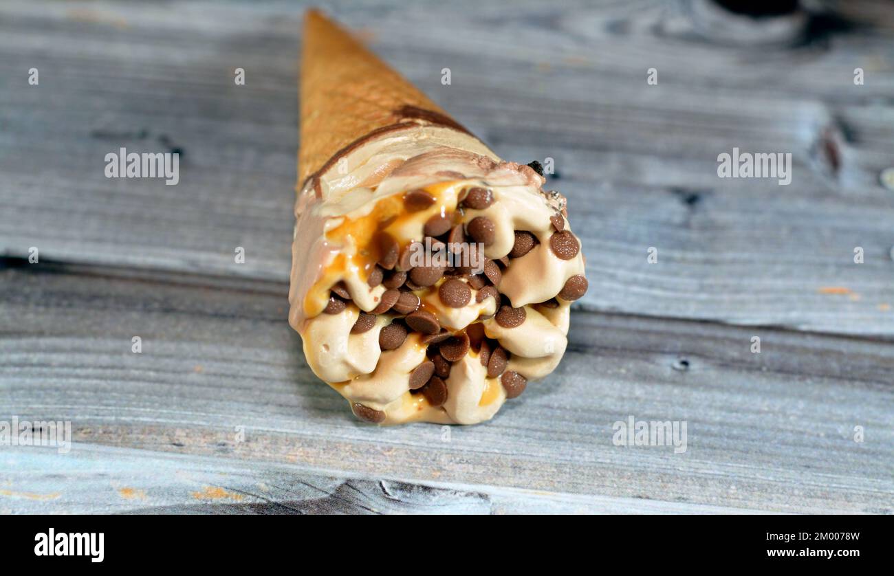 Ice cream of cocoa chocolate and vanilla cone with topping of chocolate ...