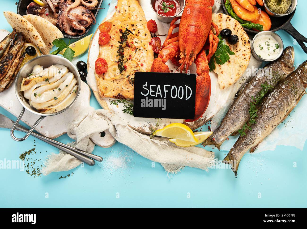 Various seafood and fishes dishes. Healthy food concept on blue ...
