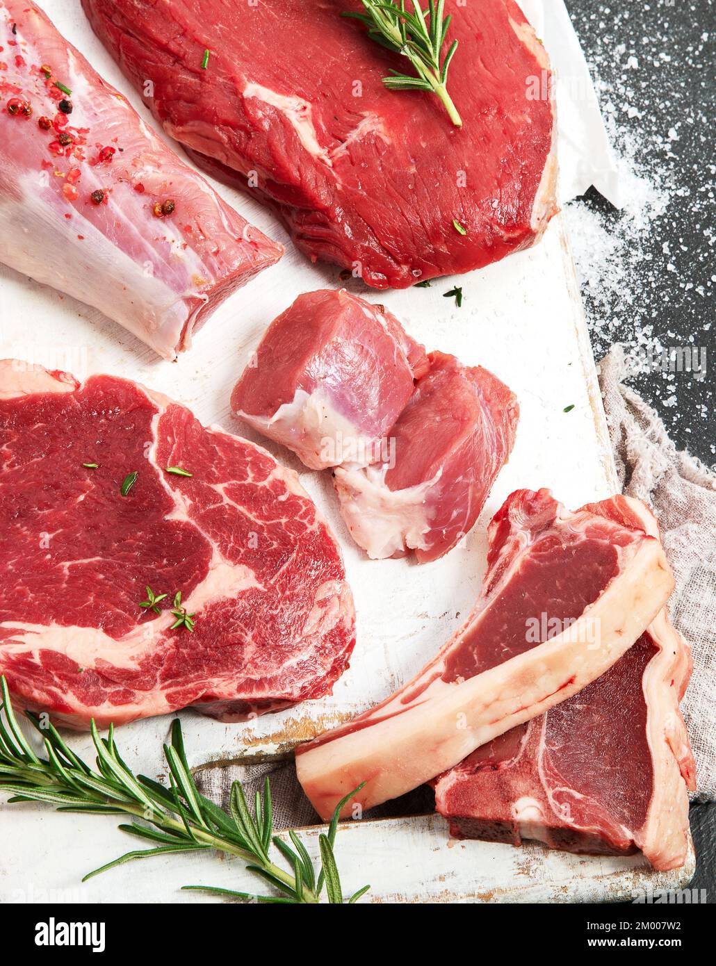 Different types of raw meat - beef, pork, lamb, chicken on dark ...