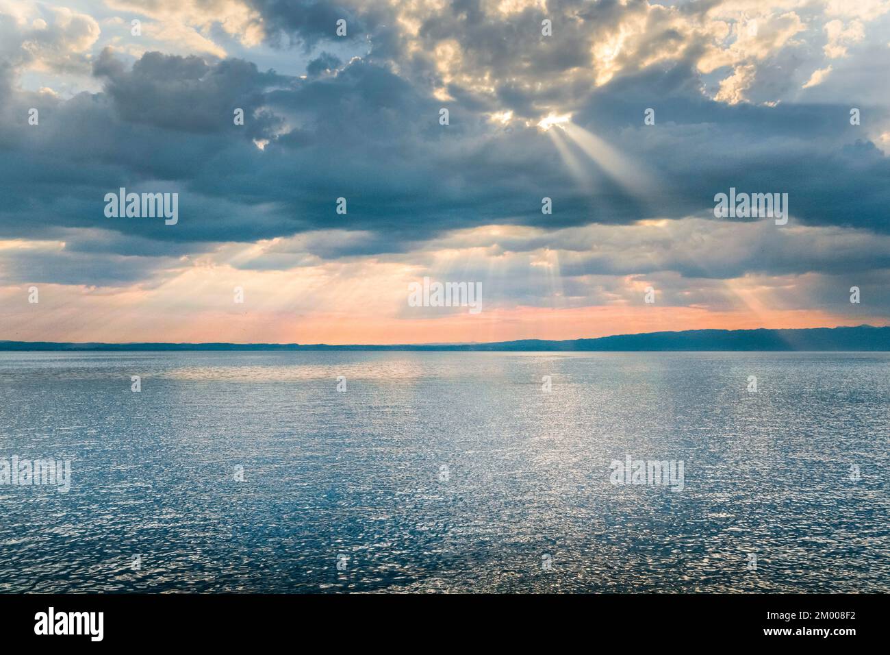 Tyndall effect over Lake Constance, sun rays break through cloudy sky ...