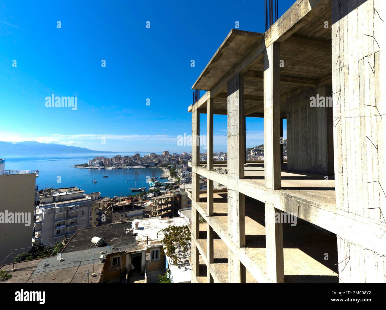 Building boom, shell in Saranda with city view of the ferry port ...