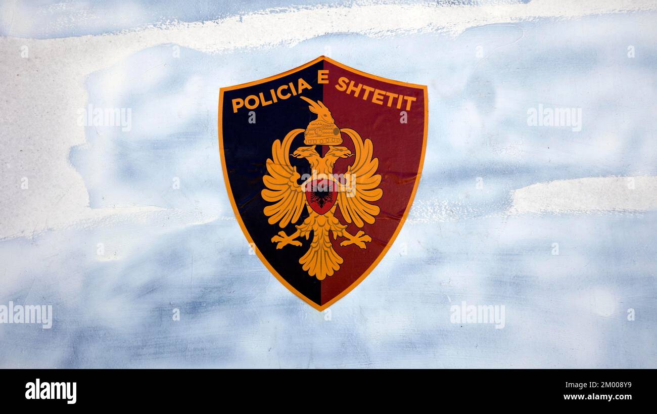 Police emblem of the state police in Albania on a blue wall, Saranda ...