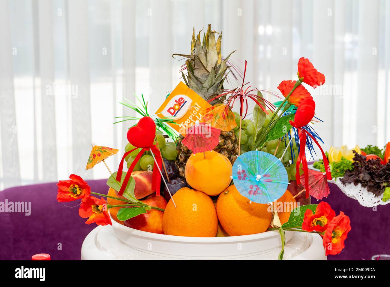 A vase with delicious fruits on the festive table. Many different sweet ...
