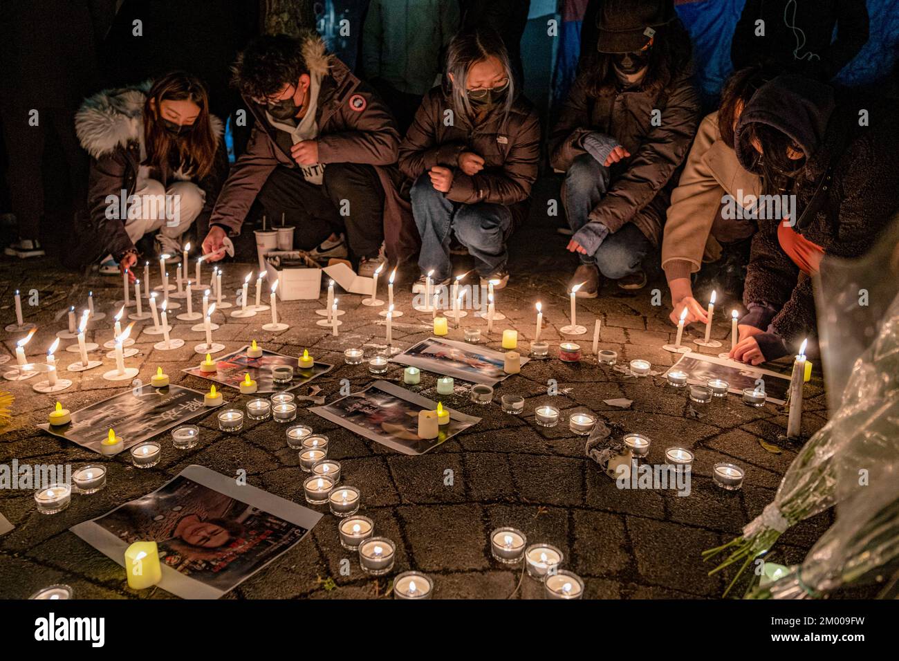Boston, United States. 02nd Dec, 2022. Demonstrators place lit candles ...