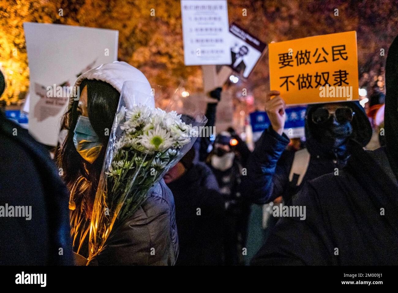 Boston, United States. 02nd Dec, 2022. A demonstrator holds flowers ...