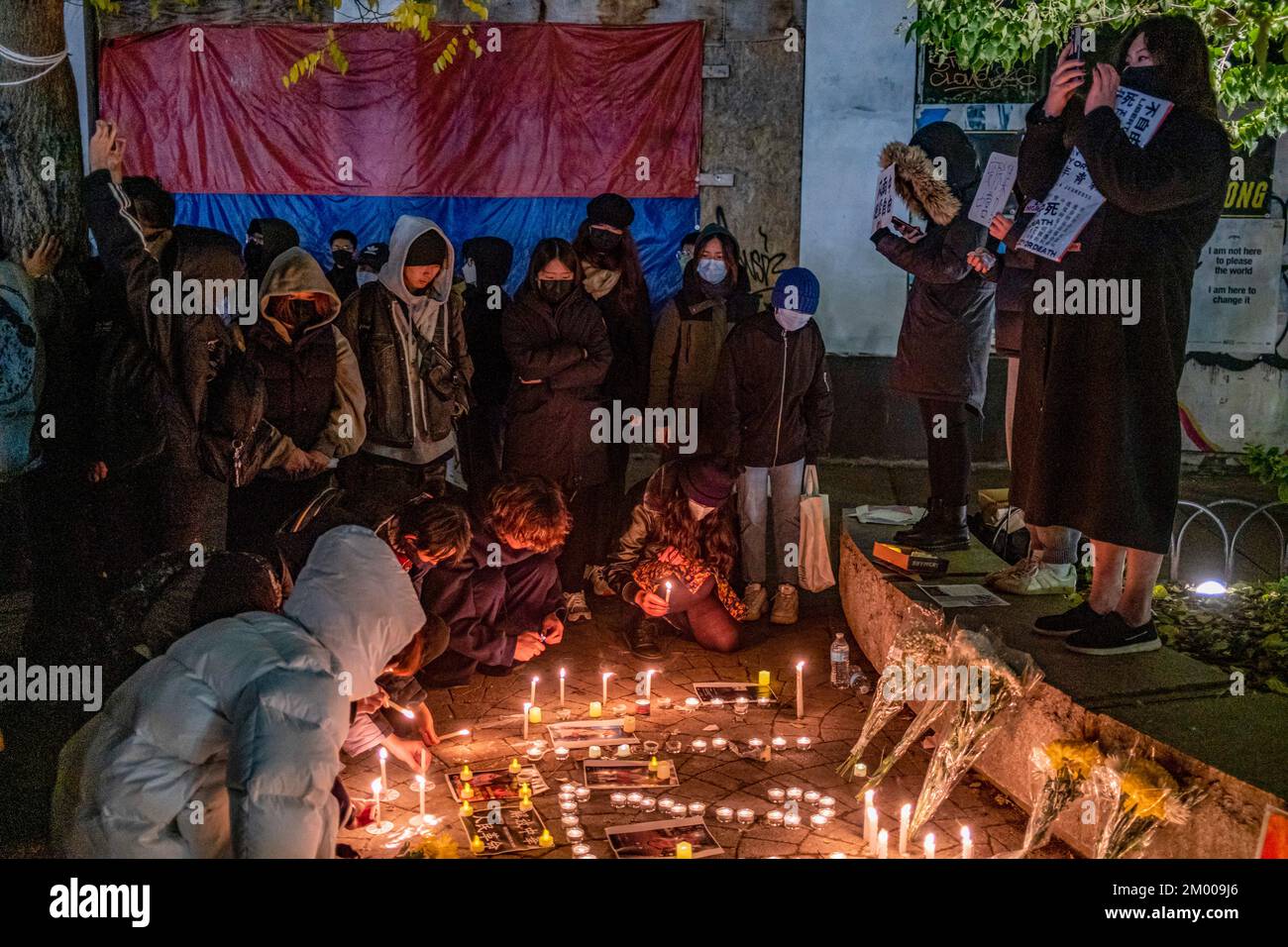 Boston, United States. 02nd Dec, 2022. Demonstrators place lit candles ...