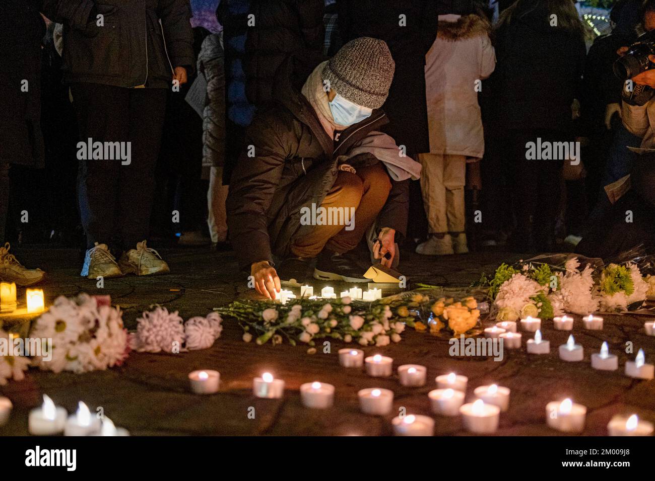 Boston, United States. 02nd Dec, 2022. A demonstrator places a lit ...