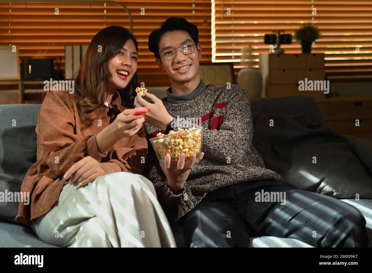 Couple watching moving, television streaming services while sitting on ...